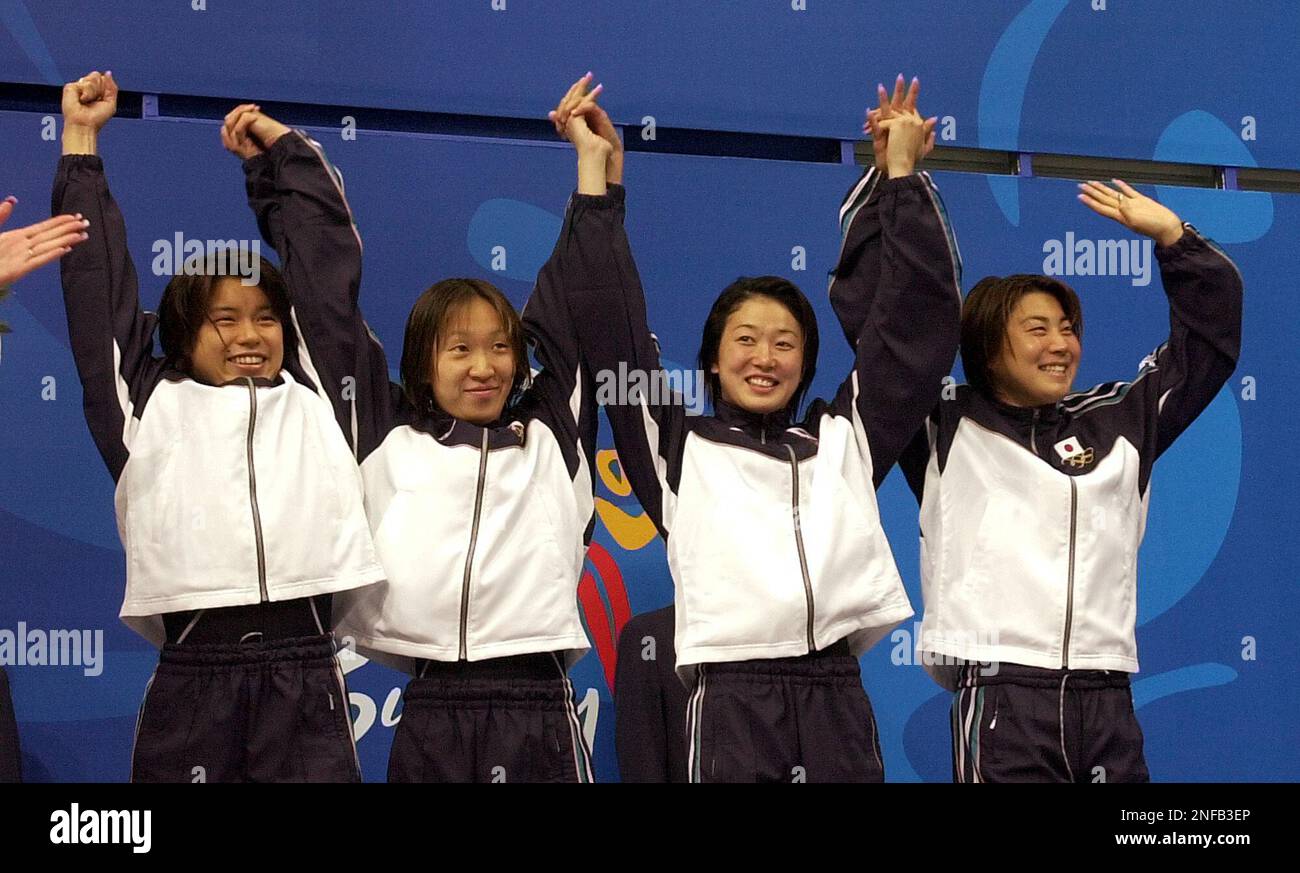 Members of the Japanese women's 4 x 100m relay team celebrate winning ...