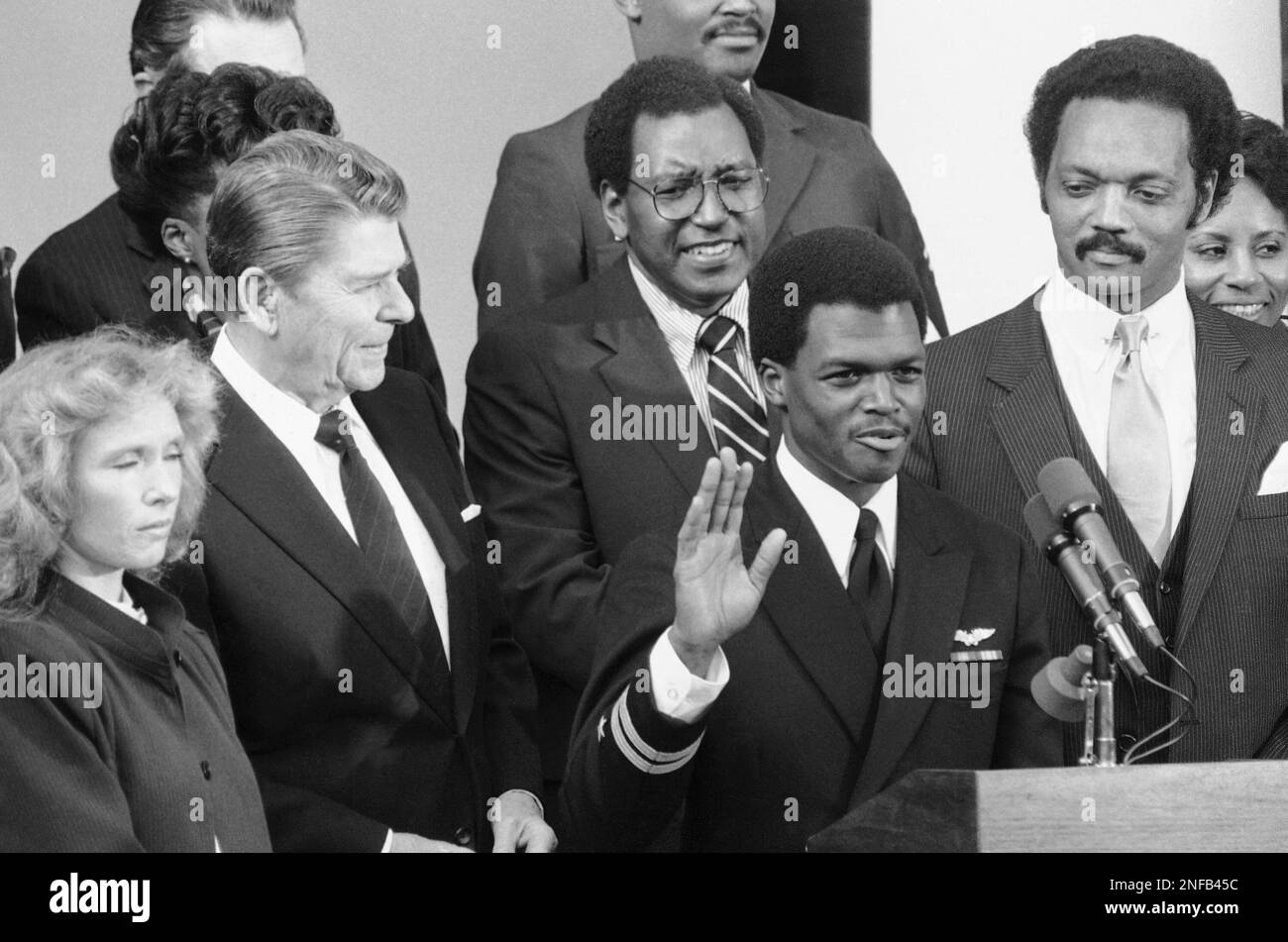 Navy Lt. Robert Goodman Jr. holds his hand up while making remarks ...