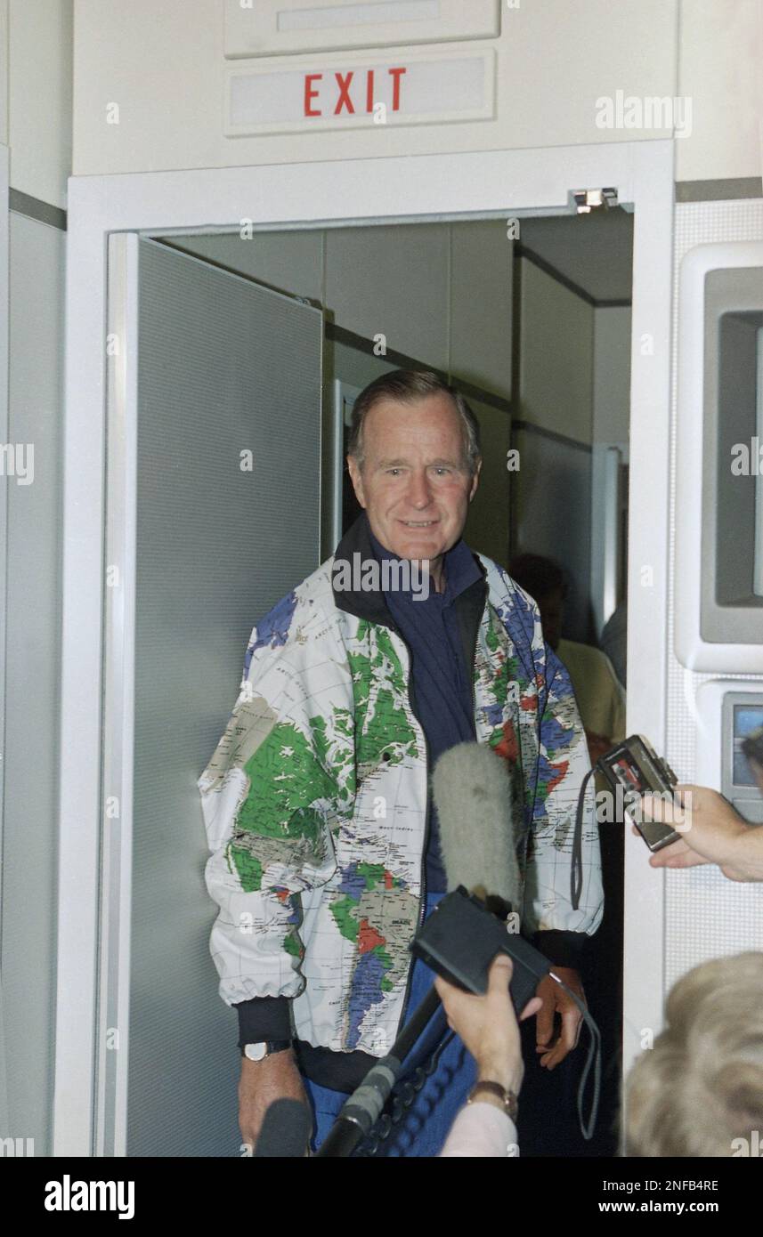 President George Bush shows off a new jacket emblazoned with a map of ...