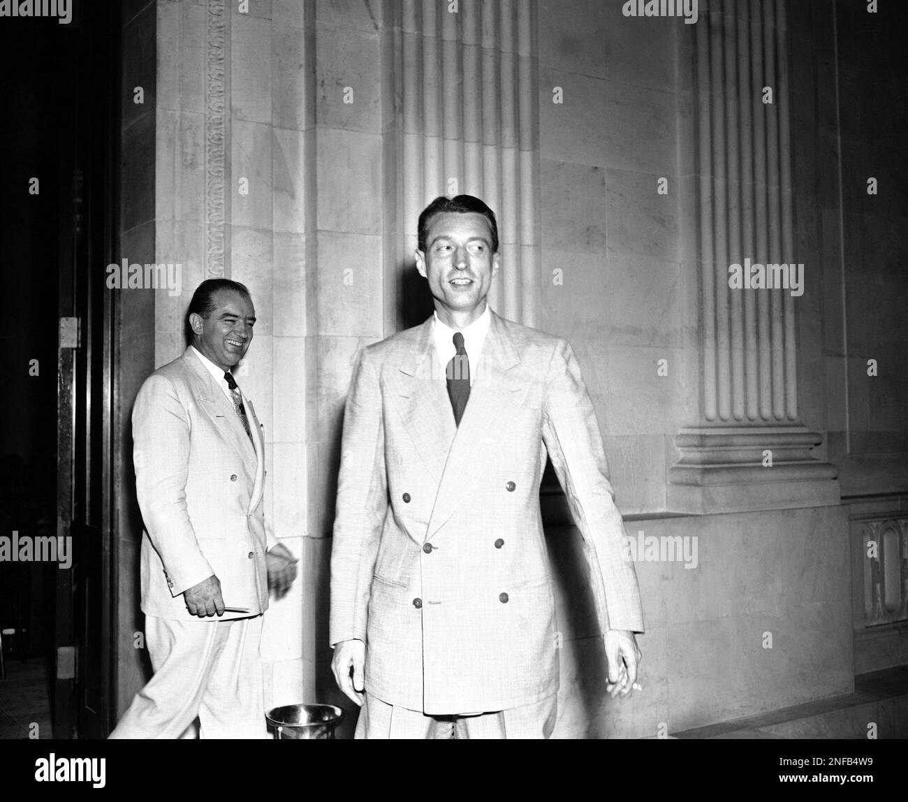 Career diplomat John S. Service, right, walks out of a Senate hearing ...