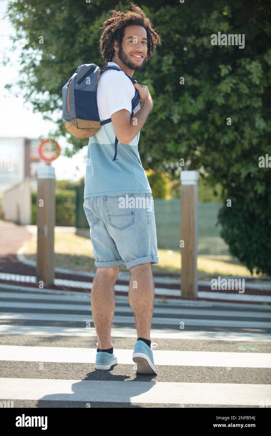 man walking across a zebra crossing Stock Photo - Alamy