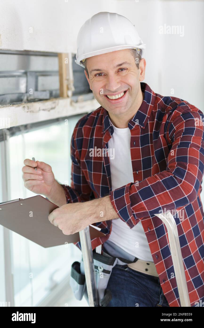 engineer with clipboard up on the ladder Stock Photo - Alamy