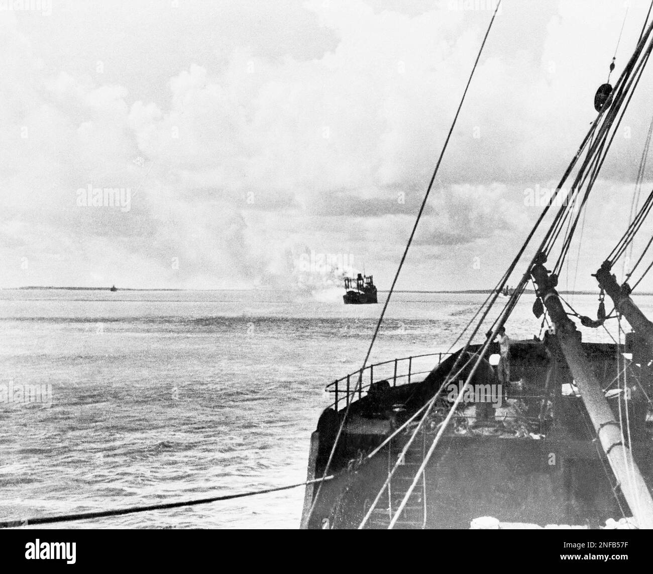 The U.S. Army troop ship Meigs, at left, burns at Port Darwin ...