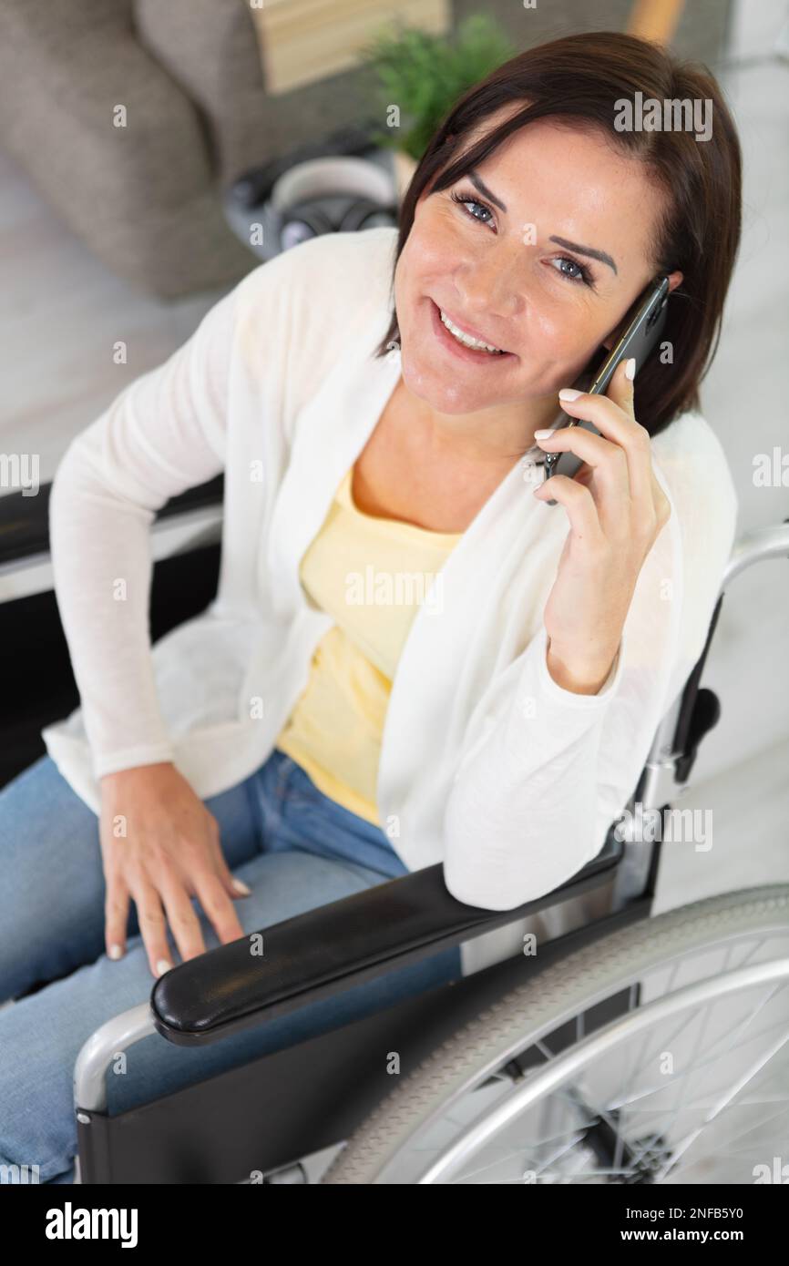disabled woman at home using cellphone Stock Photo - Alamy