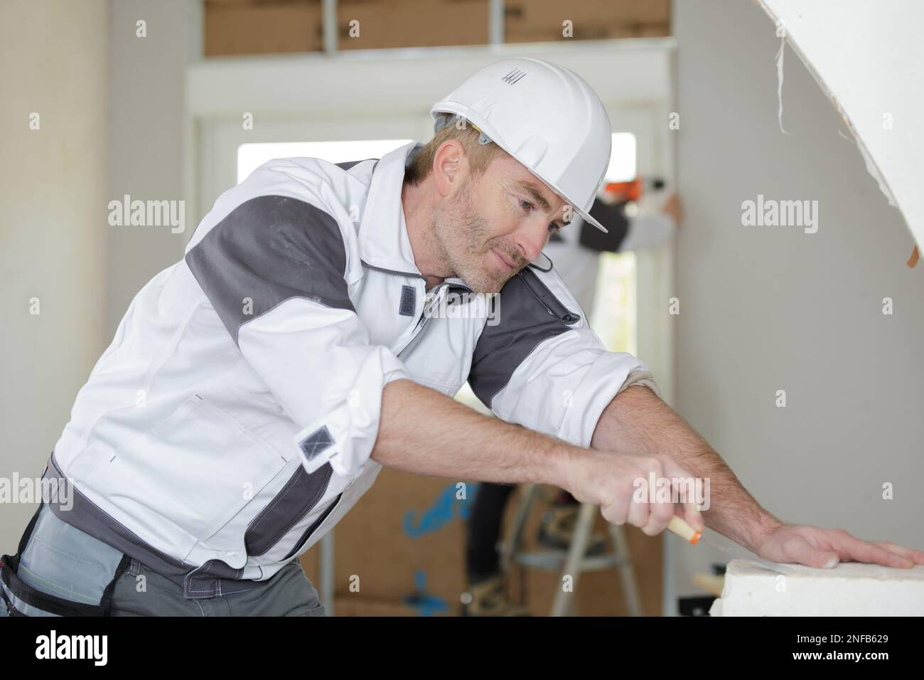 man cutting wood with a small hand saw Stock Photo - Alamy