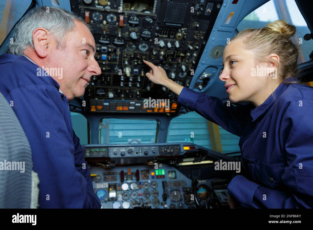 airport staff working in cockpit Stock Photo - Alamy