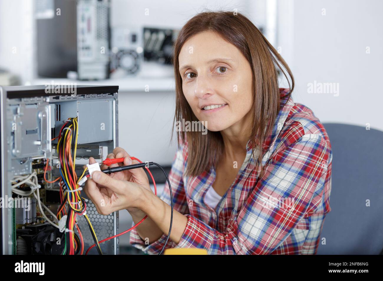 a woman fixing a computer Stock Photo - Alamy