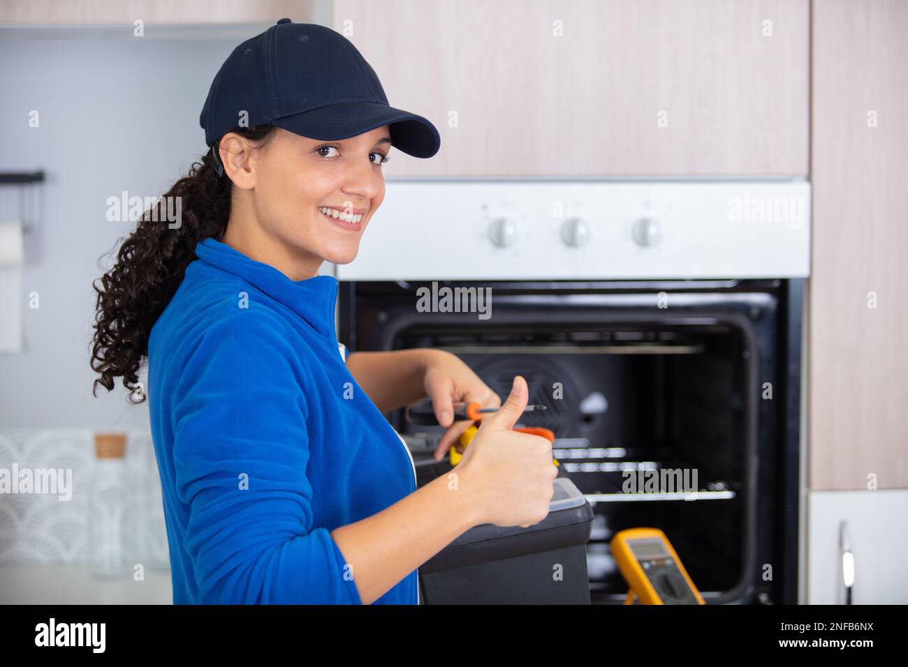 Woman man checking oven hi-res stock photography and images - Alamy