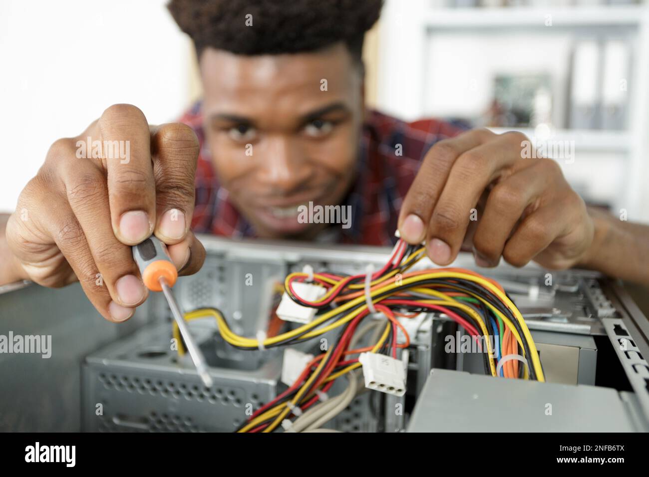 man is repairing broken pc with a screw driver Stock Photo - Alamy