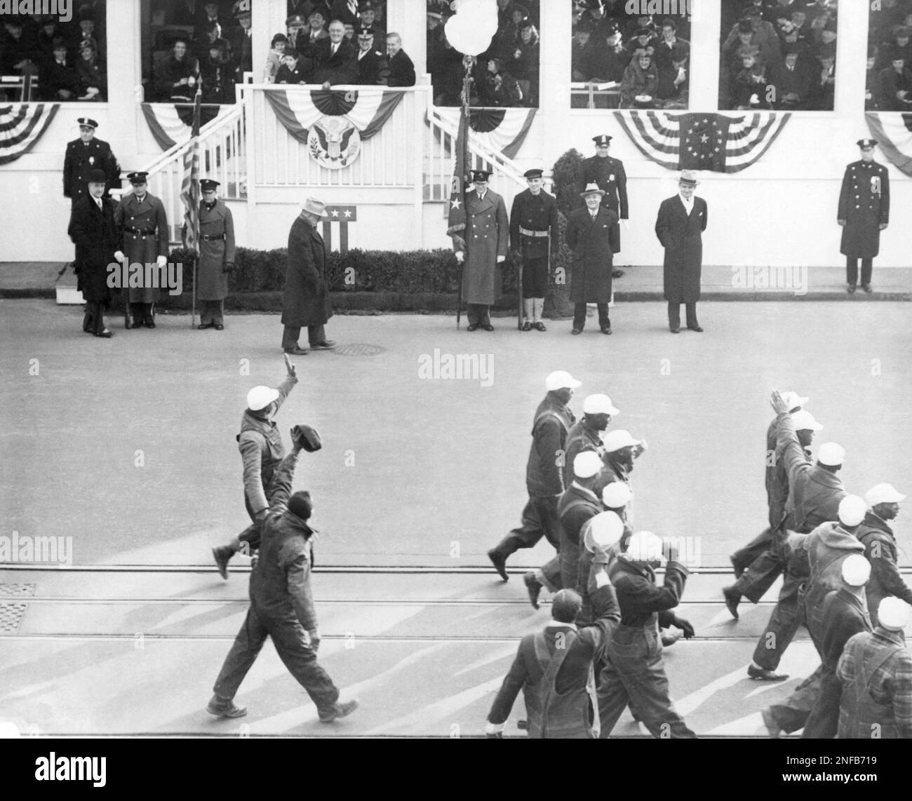 President Franklin D. Roosevelt, center on stand, smiles in ...