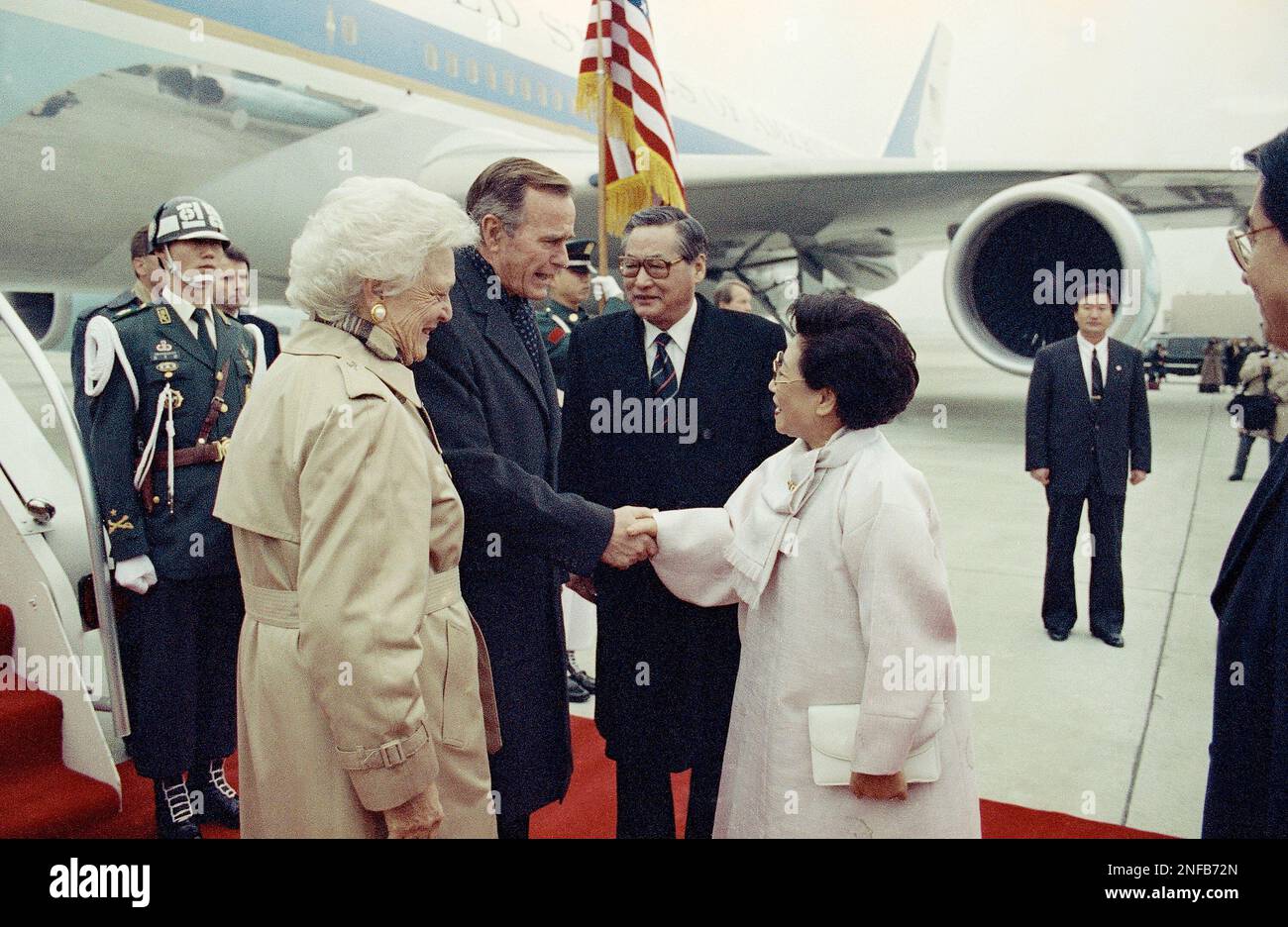 U.S. President George Bush and his wife, Barbara, are greeted upon ...