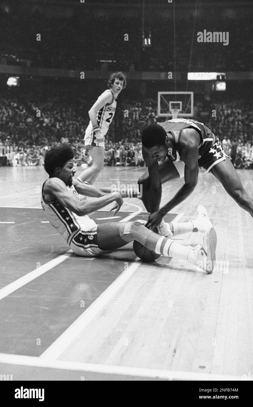 Sixers Julius Erving, left, hits the floor and Washington Bullets Bob ...