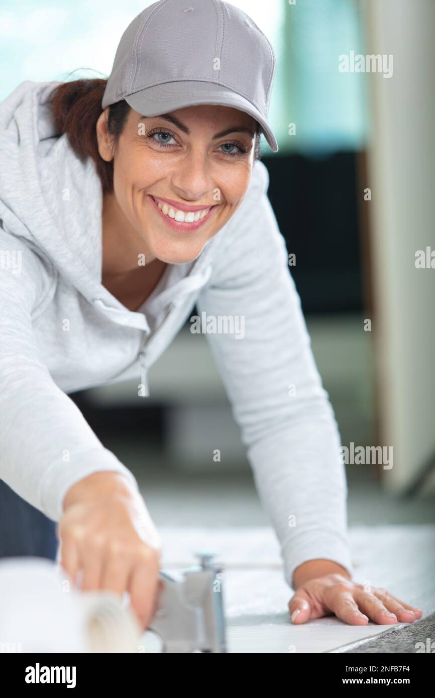 Woman tiling floor hi-res stock photography and images - Alamy