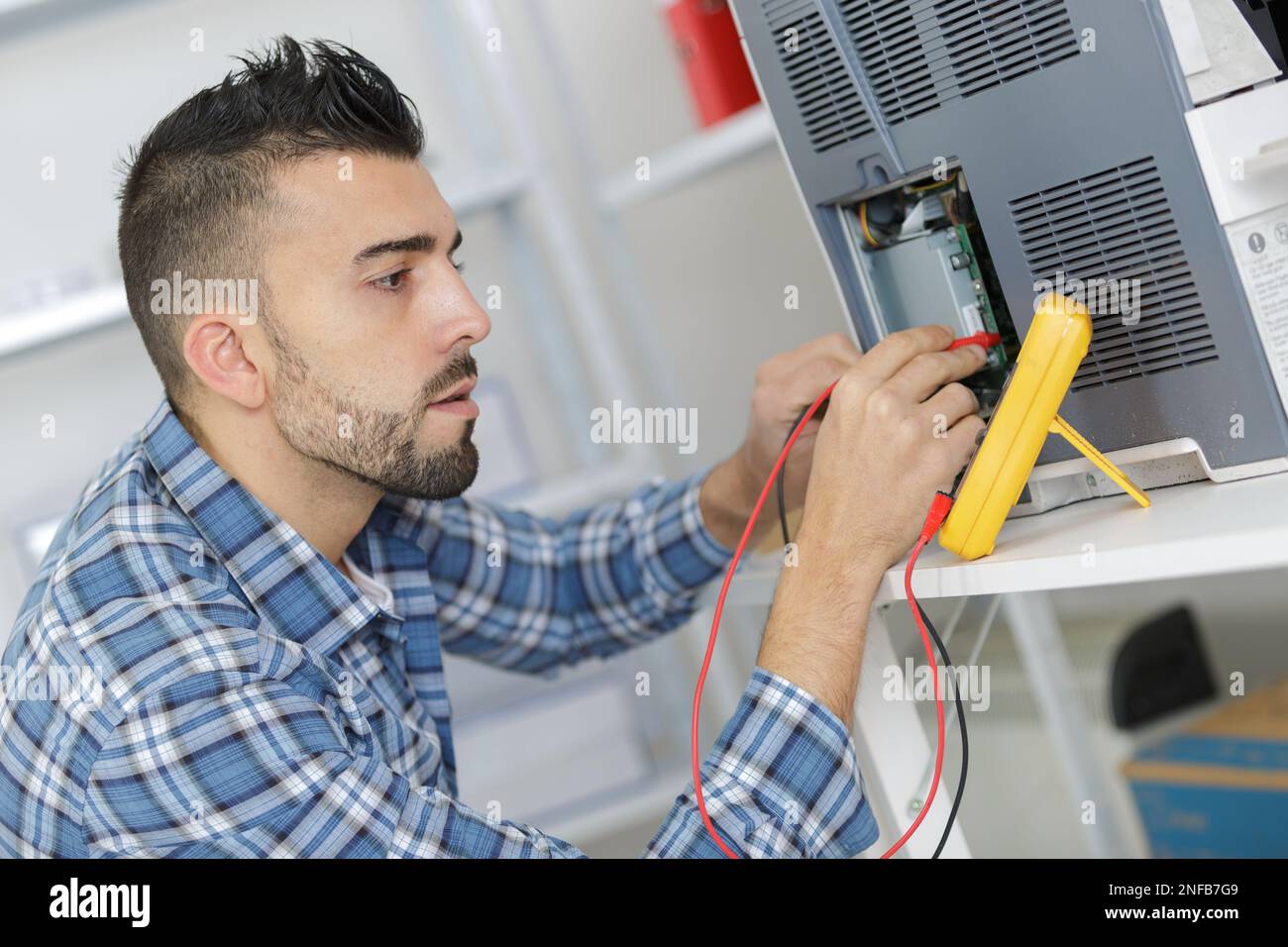 technician using multimeter to test computer Stock Photo - Alamy