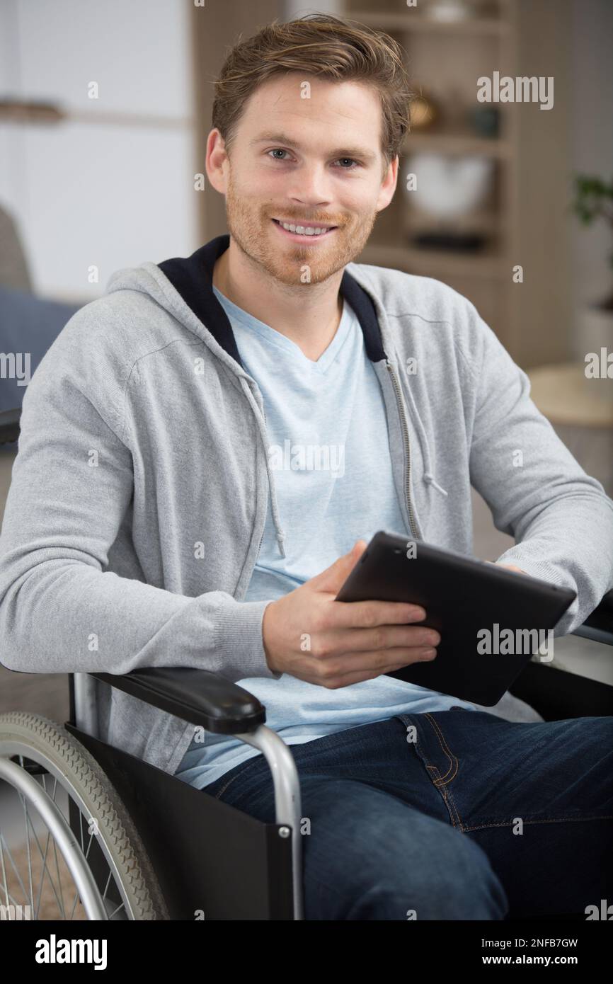 disabled man in a wheelchair using a tablet computer Stock Photo - Alamy