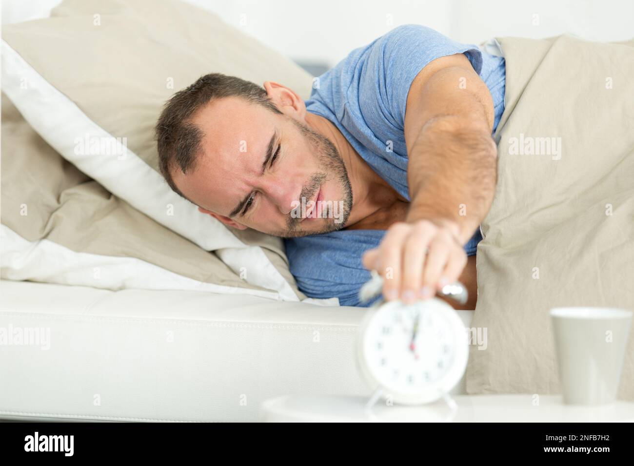 Man alarm clock switch off hi-res stock photography and images - Alamy