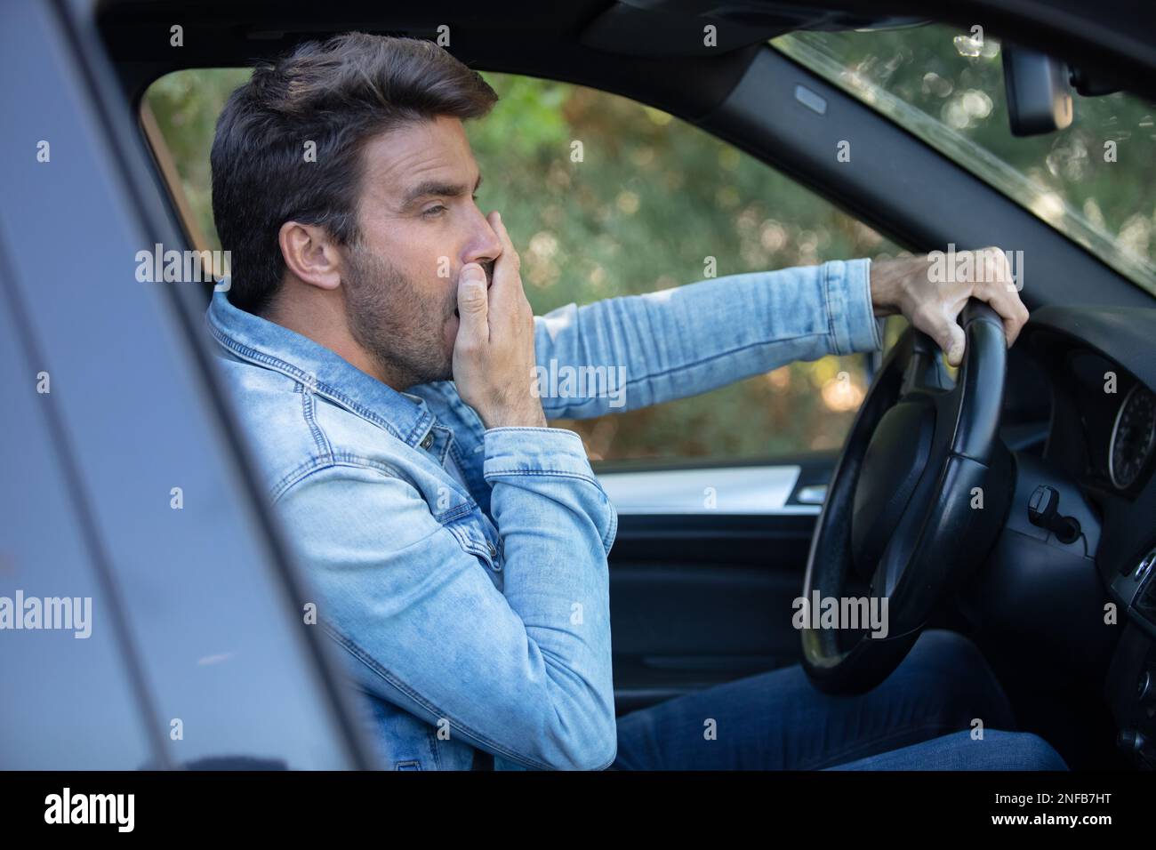 tired sleepy driver man yawning Stock Photo - Alamy