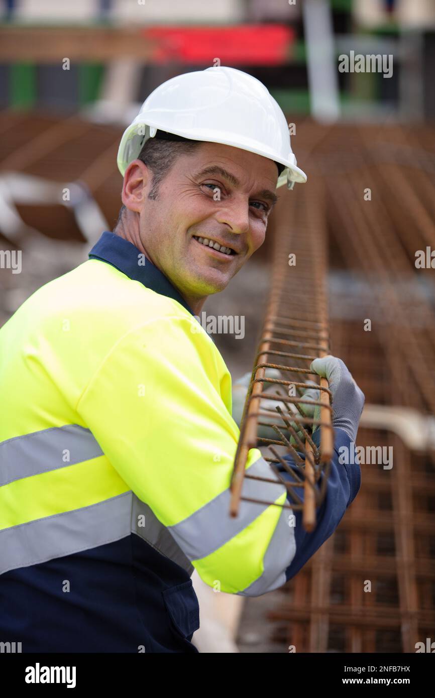 Worker carrying rebar hi-res stock photography and images - Alamy