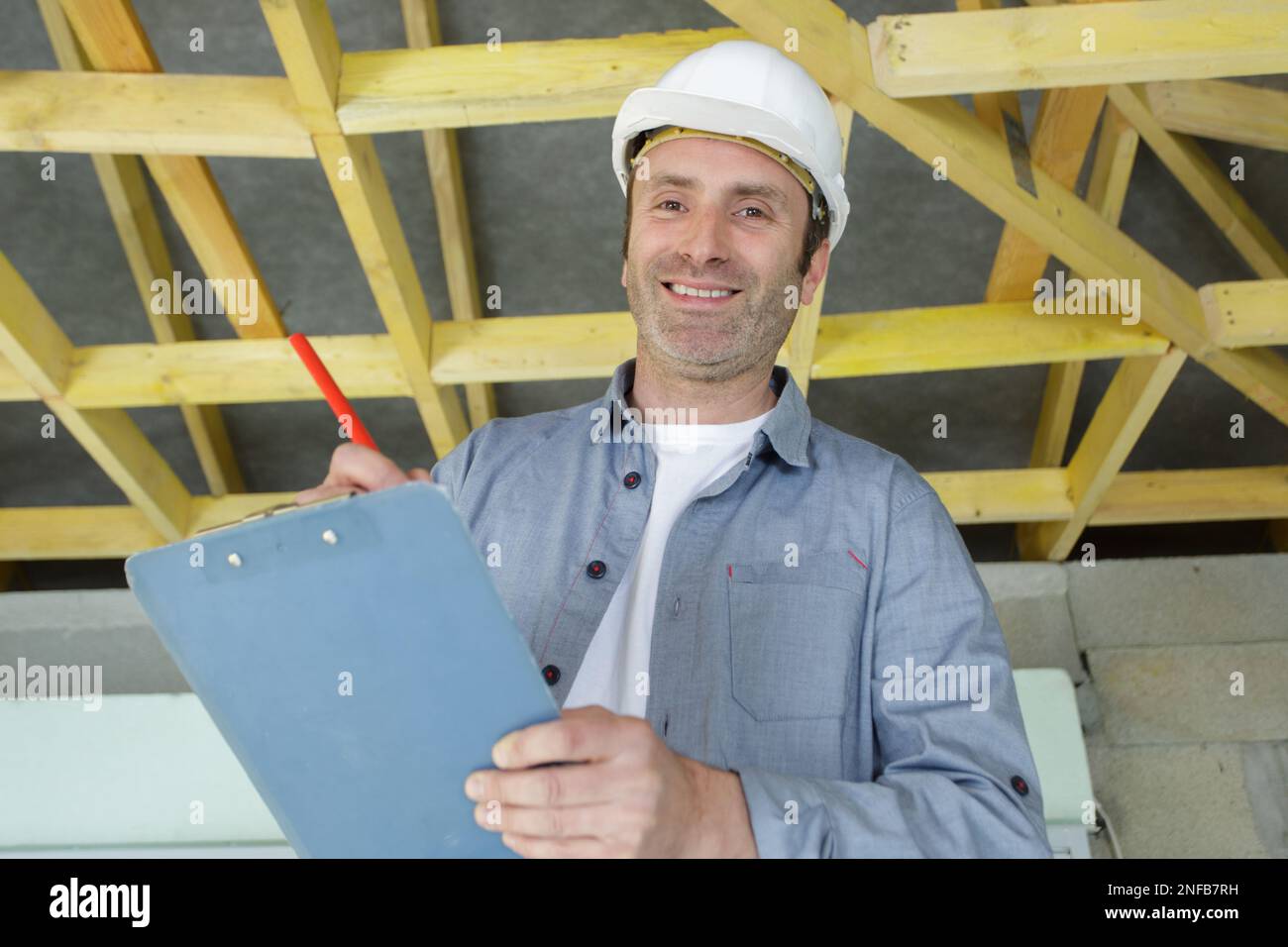 happy man construction worker smiling while holdin Stock Photo - Alamy