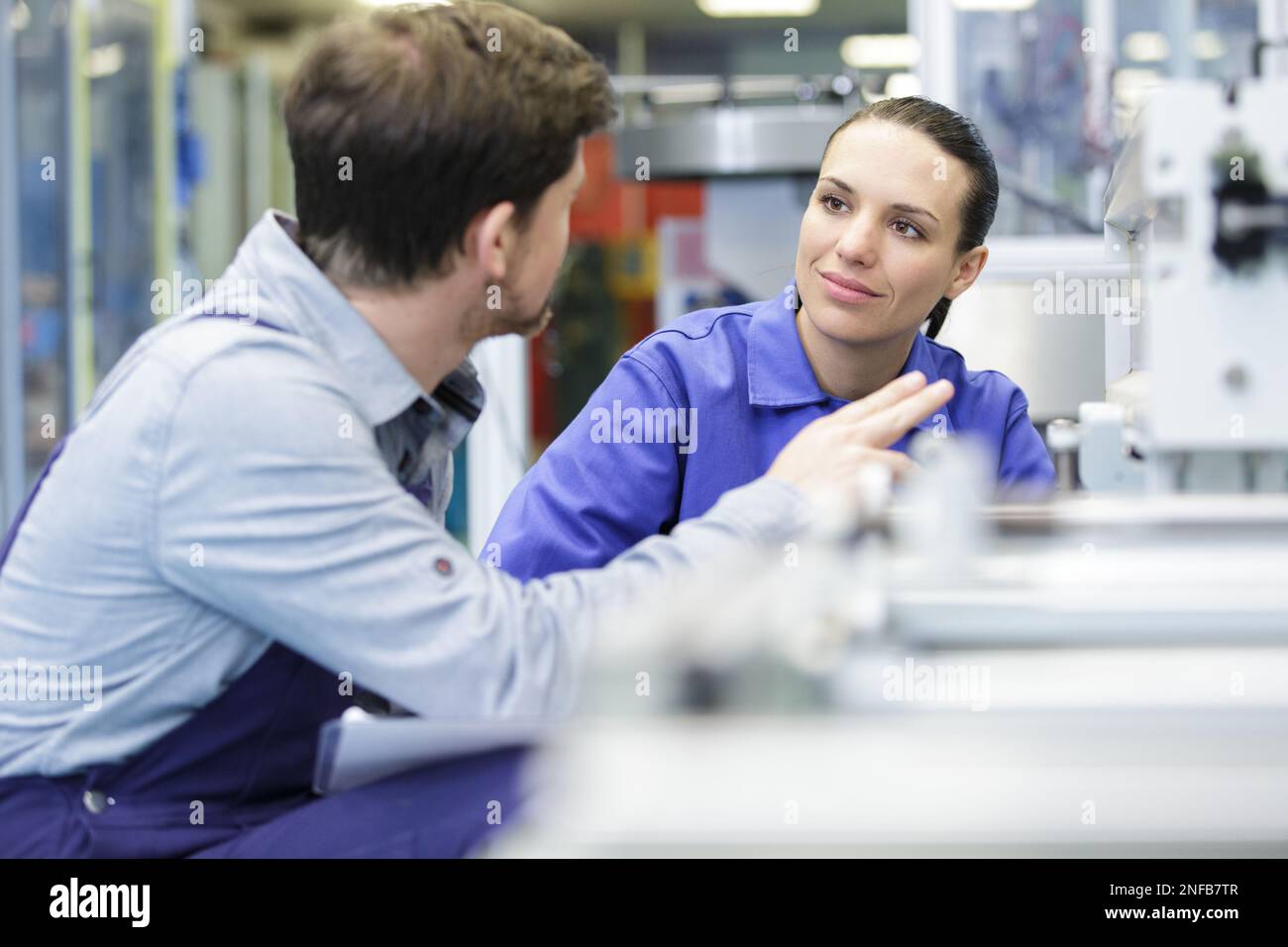 male and female factory operatives in conversation Stock Photo - Alamy