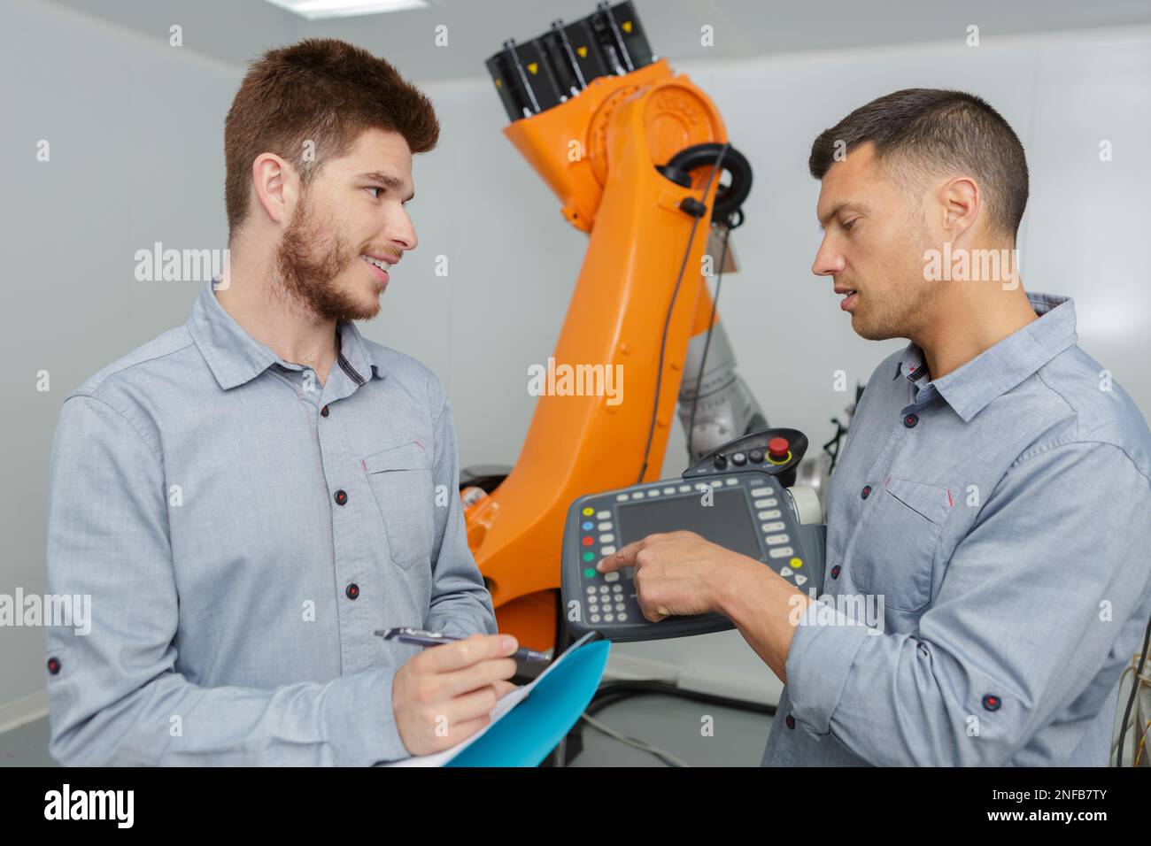 portrait of men working with robotic arm Stock Photo - Alamy