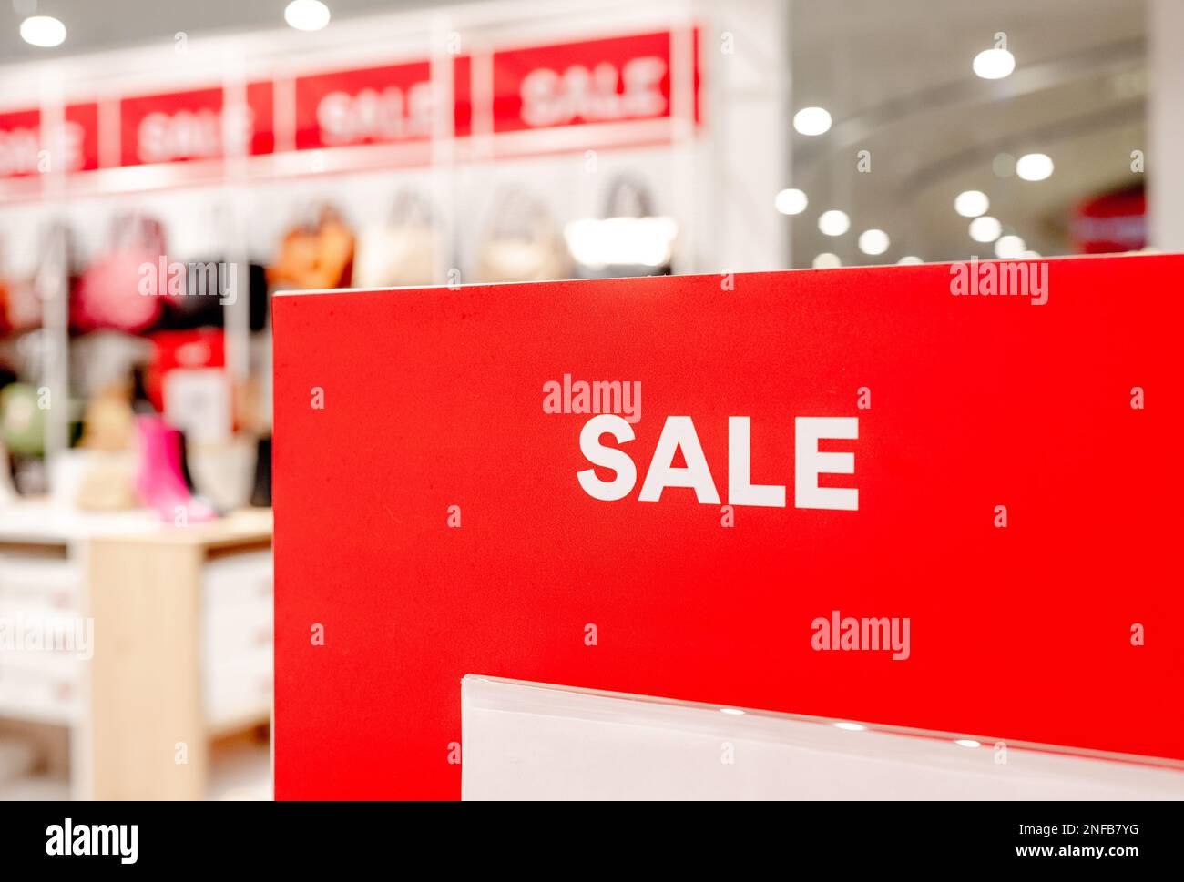 Sale season offers sign in commercial shopping center Stock Photo - Alamy