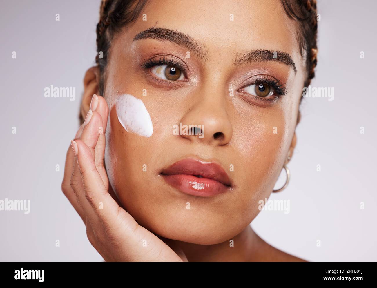 Black woman, lotion and skincare of a young model with facial mask ...