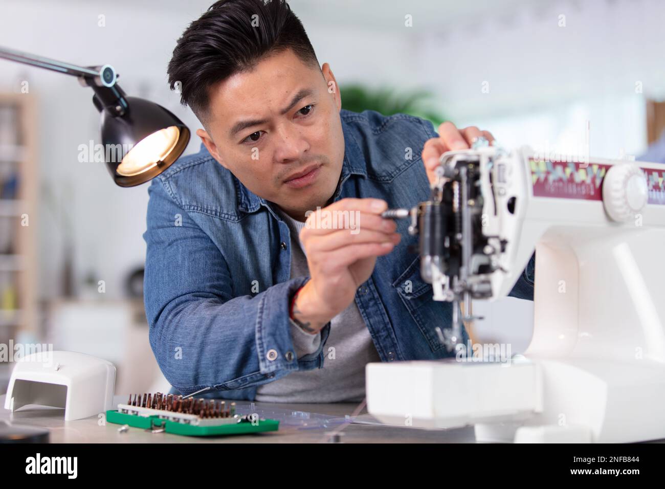 young handsome man soldering a circuit board Stock Photo - Alamy