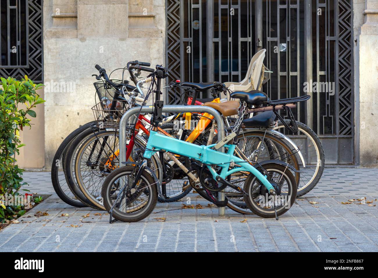 Set of different bicycles parked with chains and padlocks on the ...