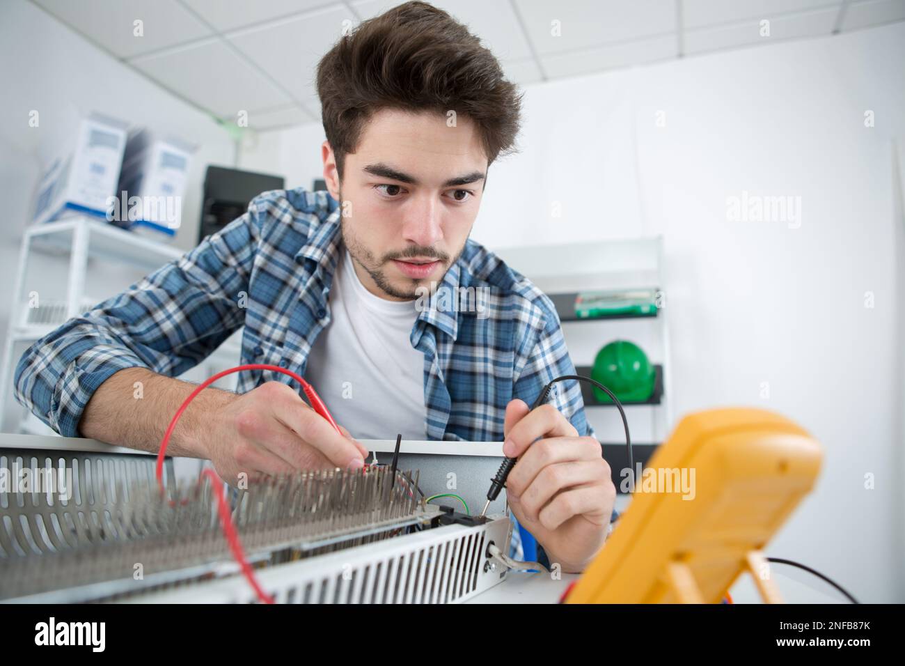 engineer working with digital multimeter in workshop Stock Photo - Alamy