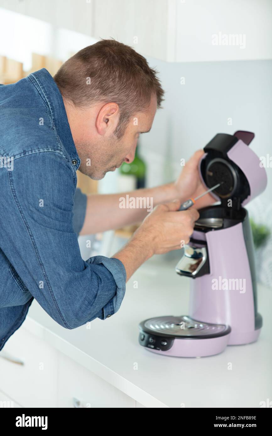 Man fixing coffee machine hi-res stock photography and images - Alamy