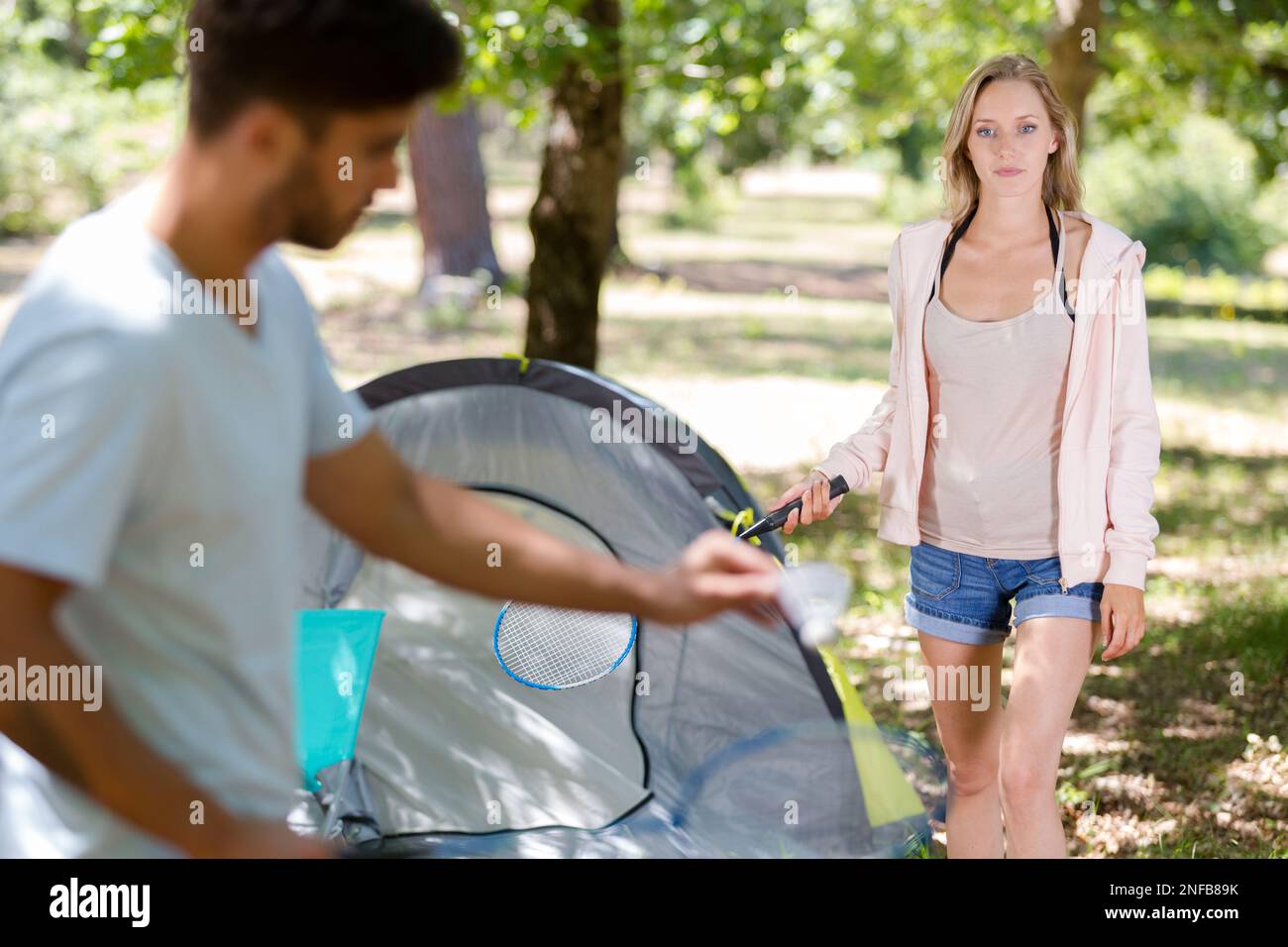 happy friends playing badminton outdoors Stock Photo - Alamy
