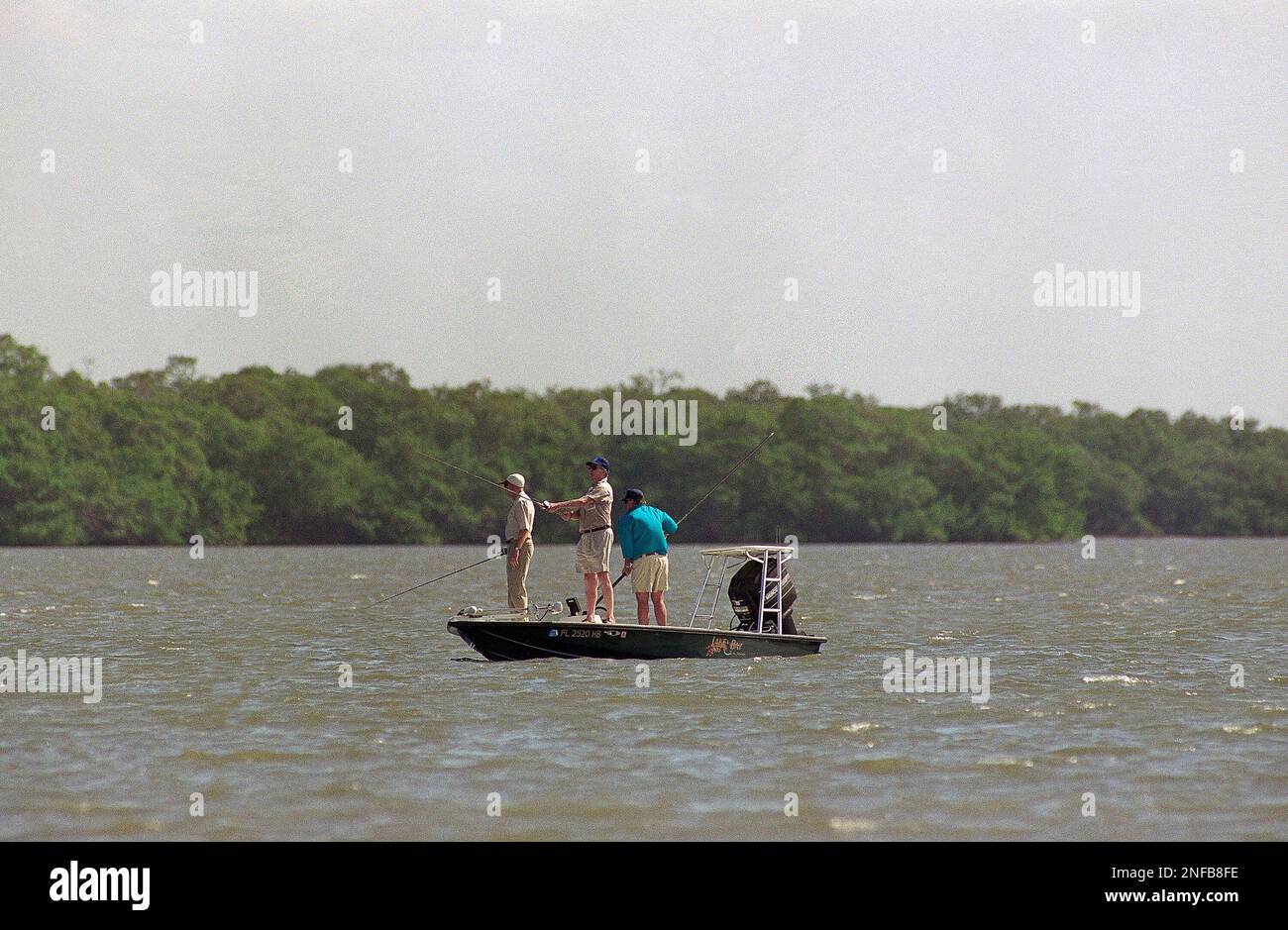 President George Bush, center, fishes in Charlotte Harbor while ...
