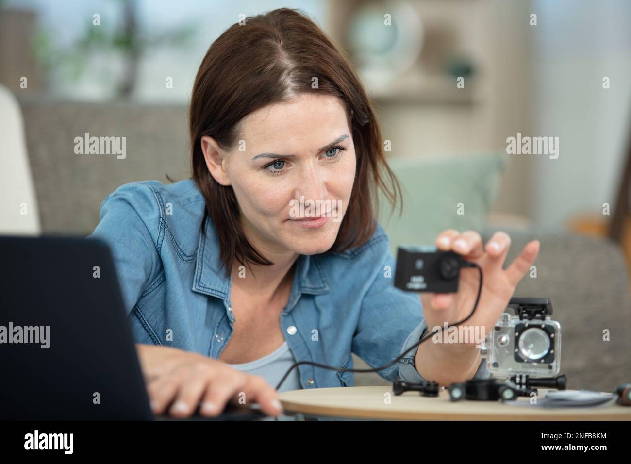 a woman is fixing a camera Stock Photo - Alamy