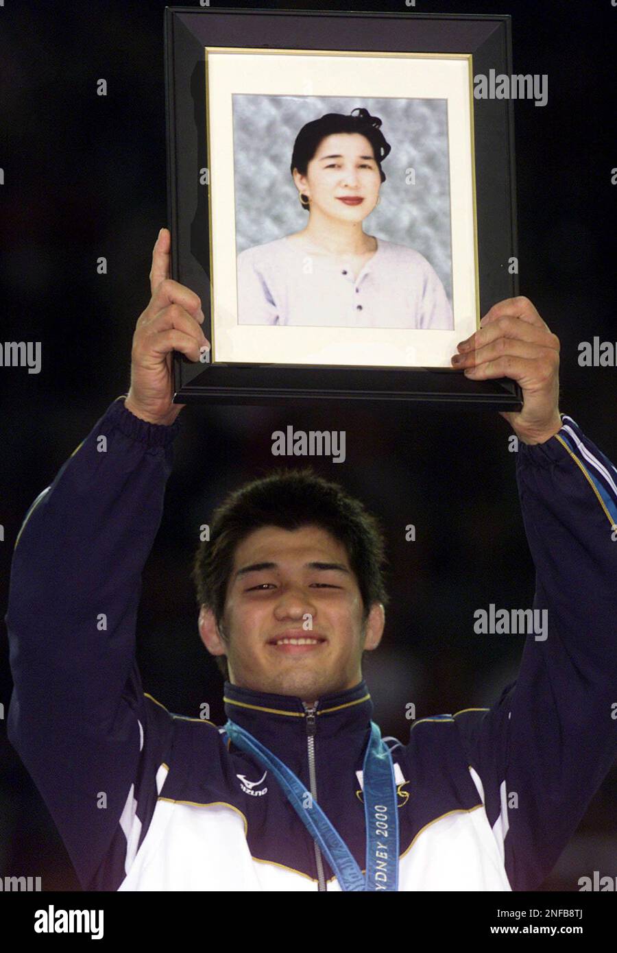 Japan's Kosei Inoue shows the picture of his dead mother Kazuko on the ...