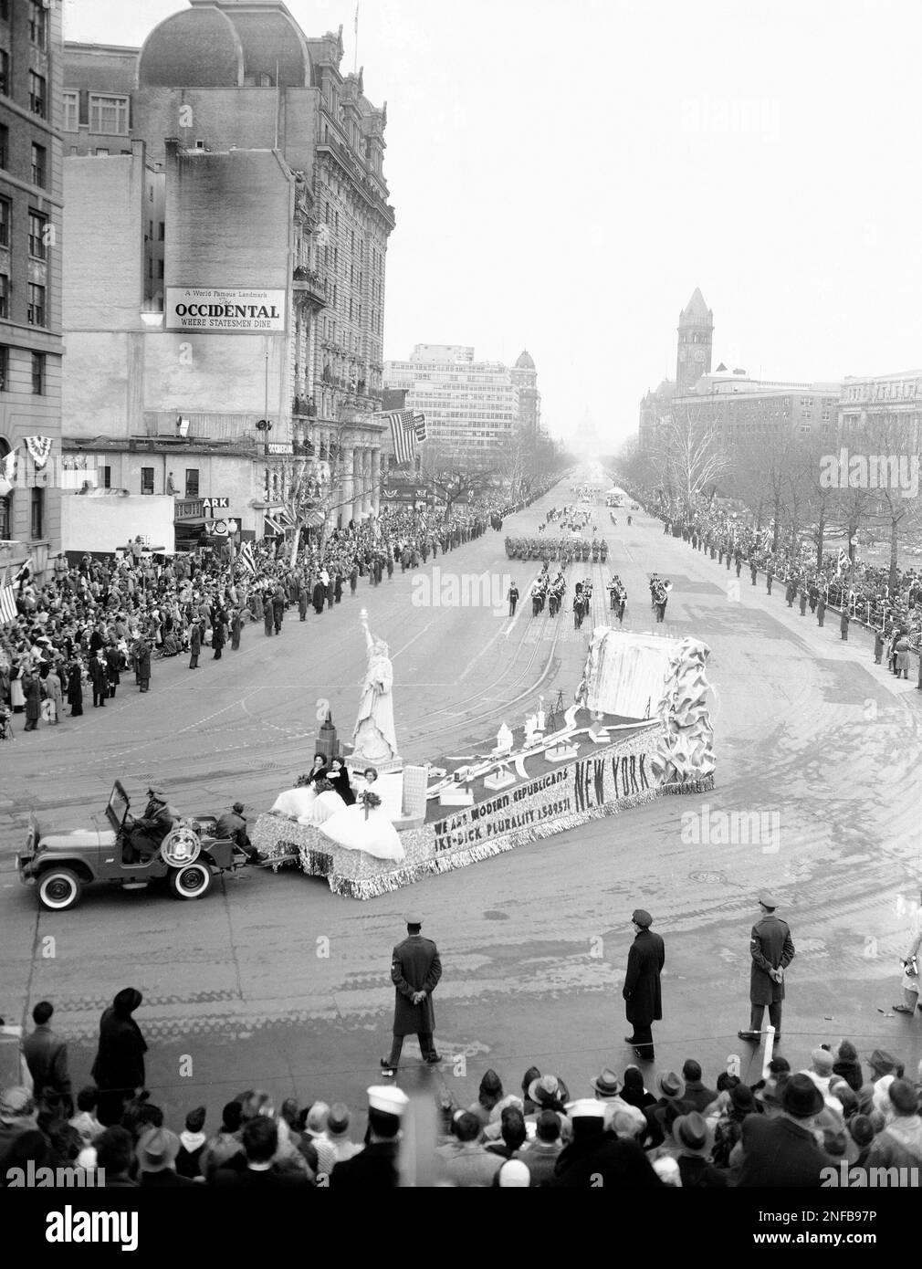 The New York State float, featuring the Statue of Liberty and Niagara Falls, makes the turn from ...