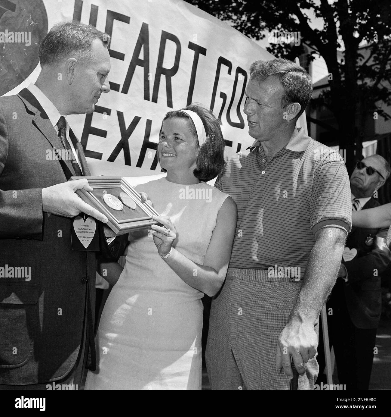 Golf master Arnold Palmer and his wife, Winnie, accept medals for their ...