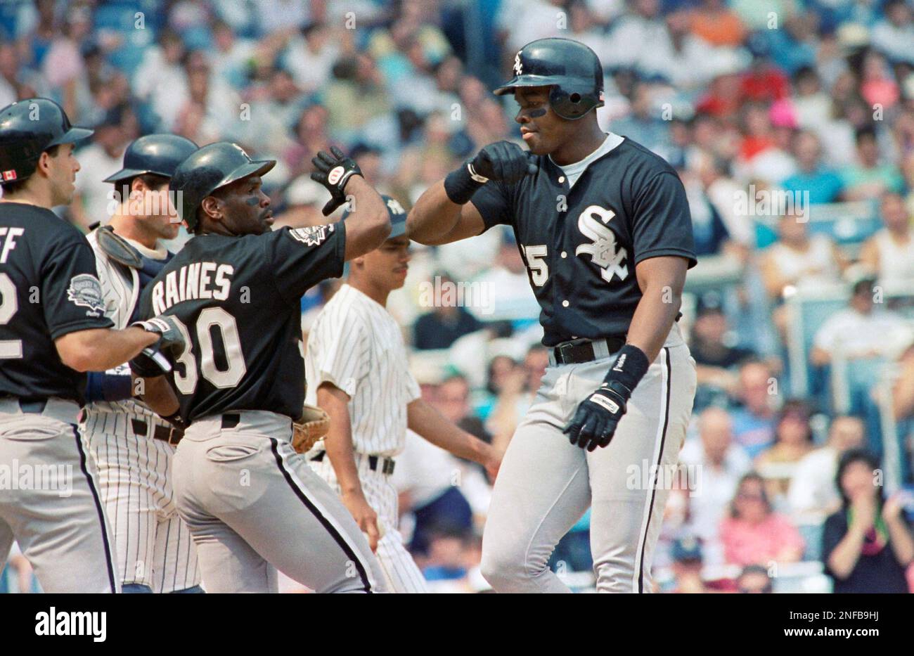 Chicago White Sox first baseman Frank Thomas is greeted at home plate ...