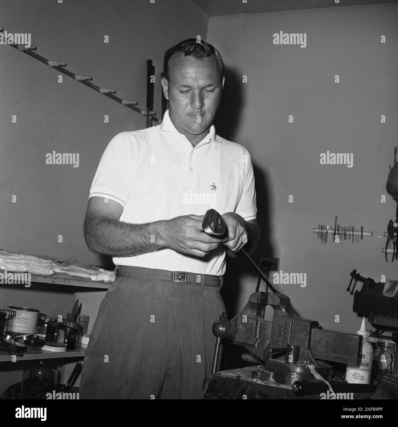 Pro golfer Arnold Palmer works on clubs in the caddy shop at Olympia ...
