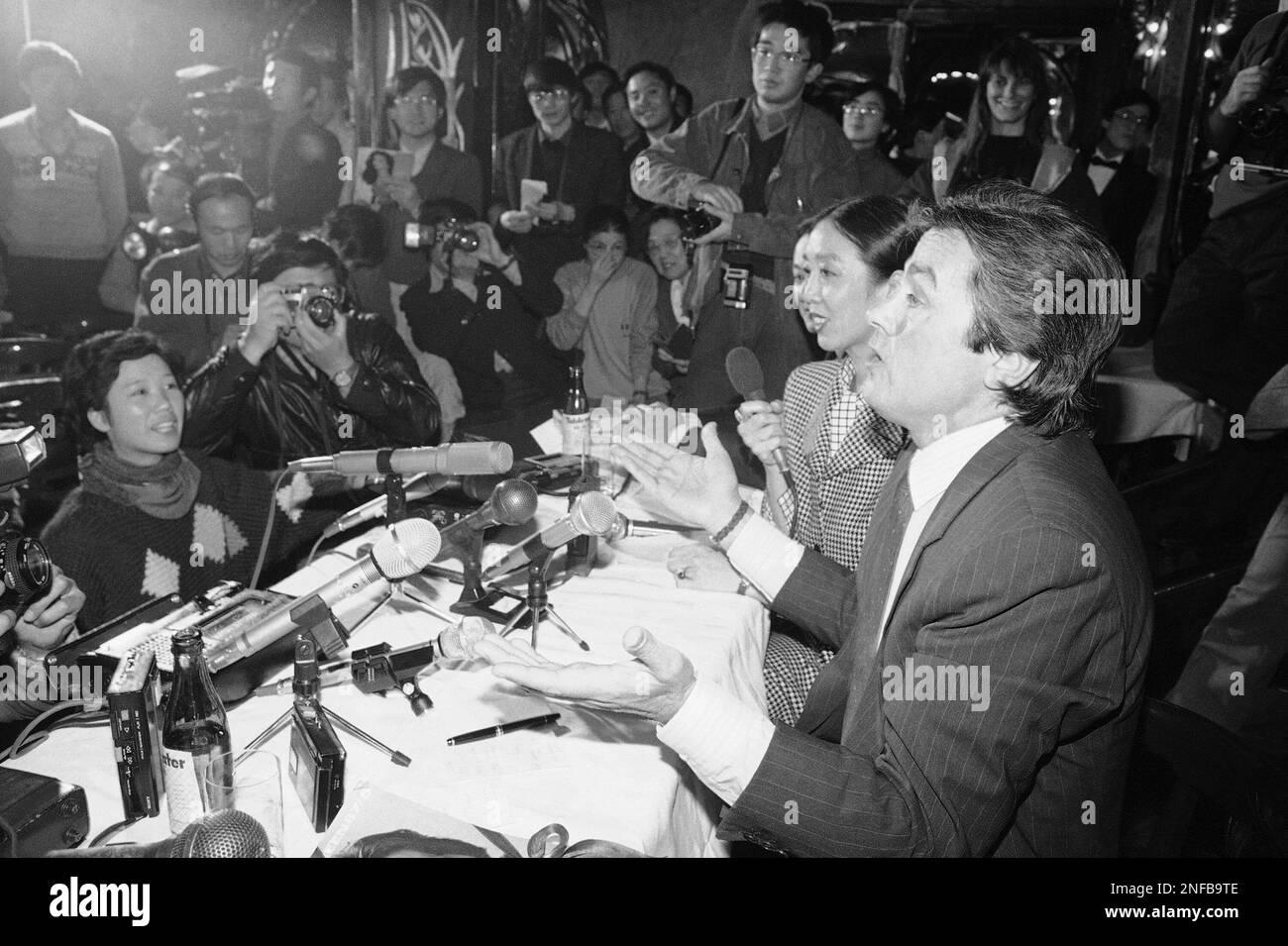French actor Alain Delon tells a throng of Chinese newsmen during a ...