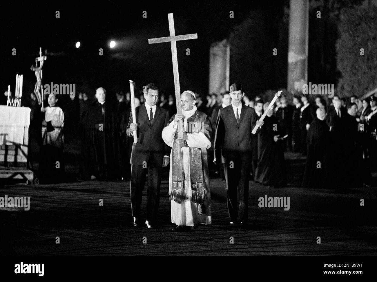 Roman Catholic Pope Paul VI carries a cross in a Good Friday procession ...