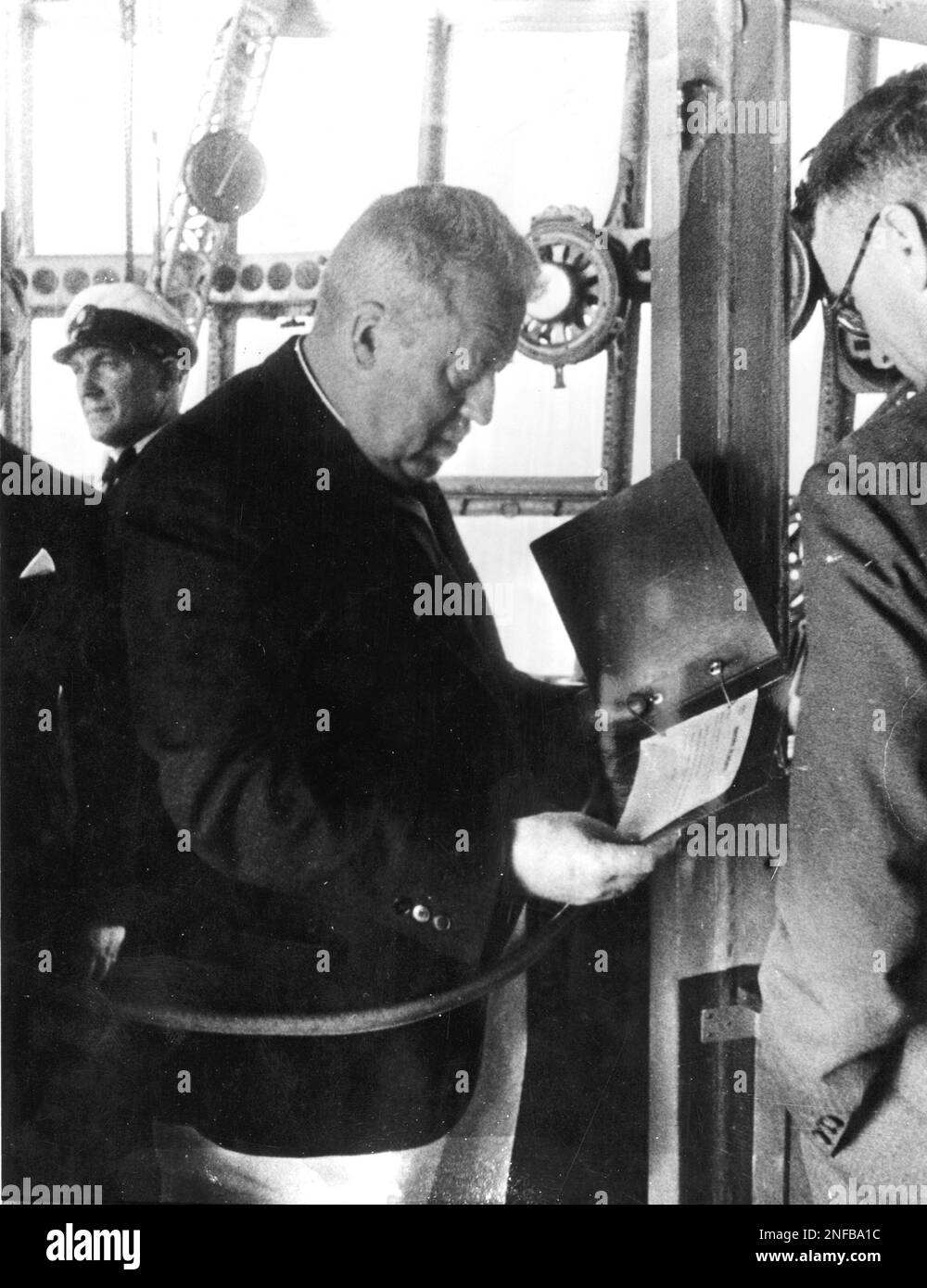 Dr. Hugo Eckener reads a telegram which just came in at the captain's gondola of the airship ...