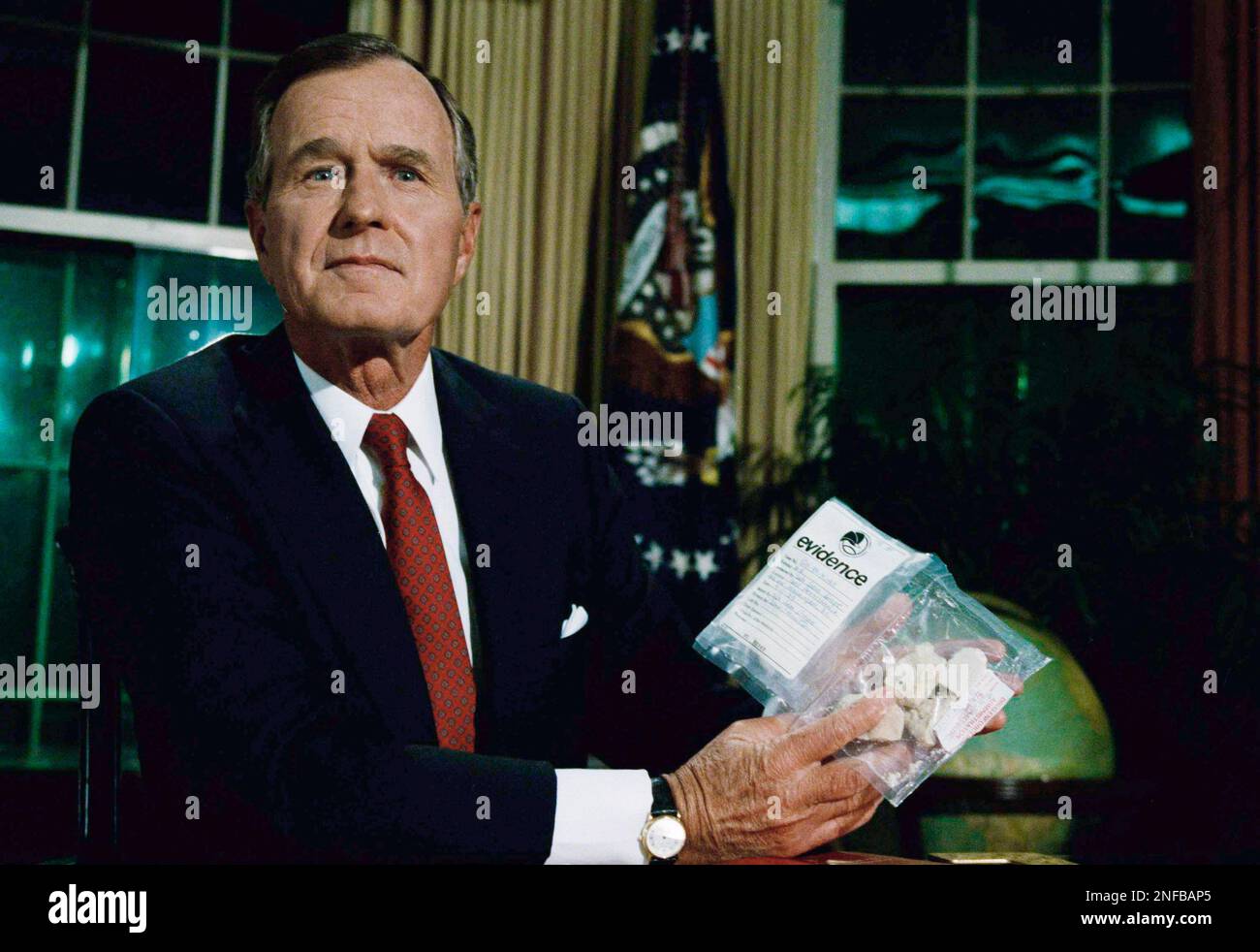 President George Bush holds a bag of crack cocaine as he poses for ...