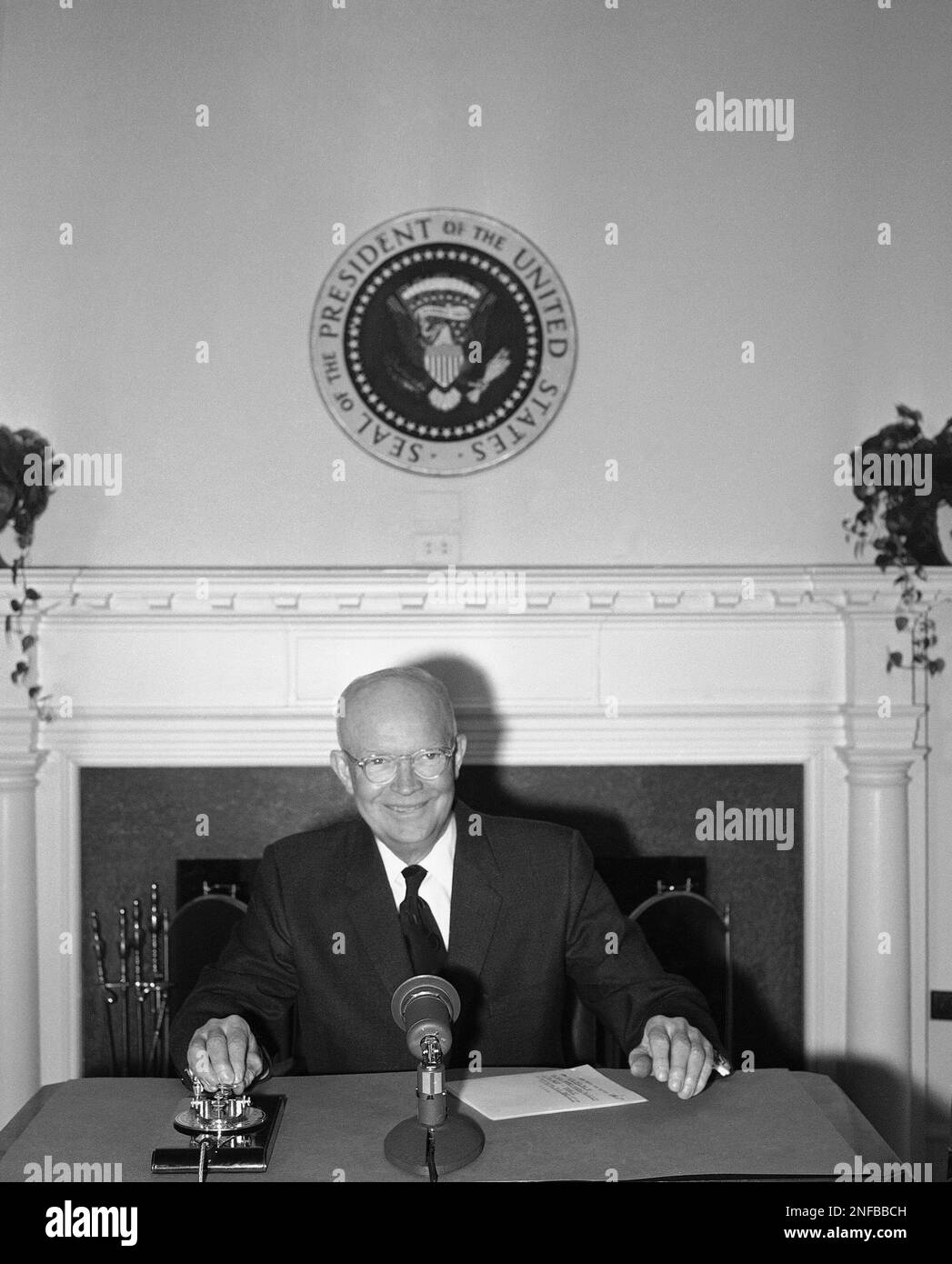 President Dwight Eisenhower presses a key at the White House in ...
