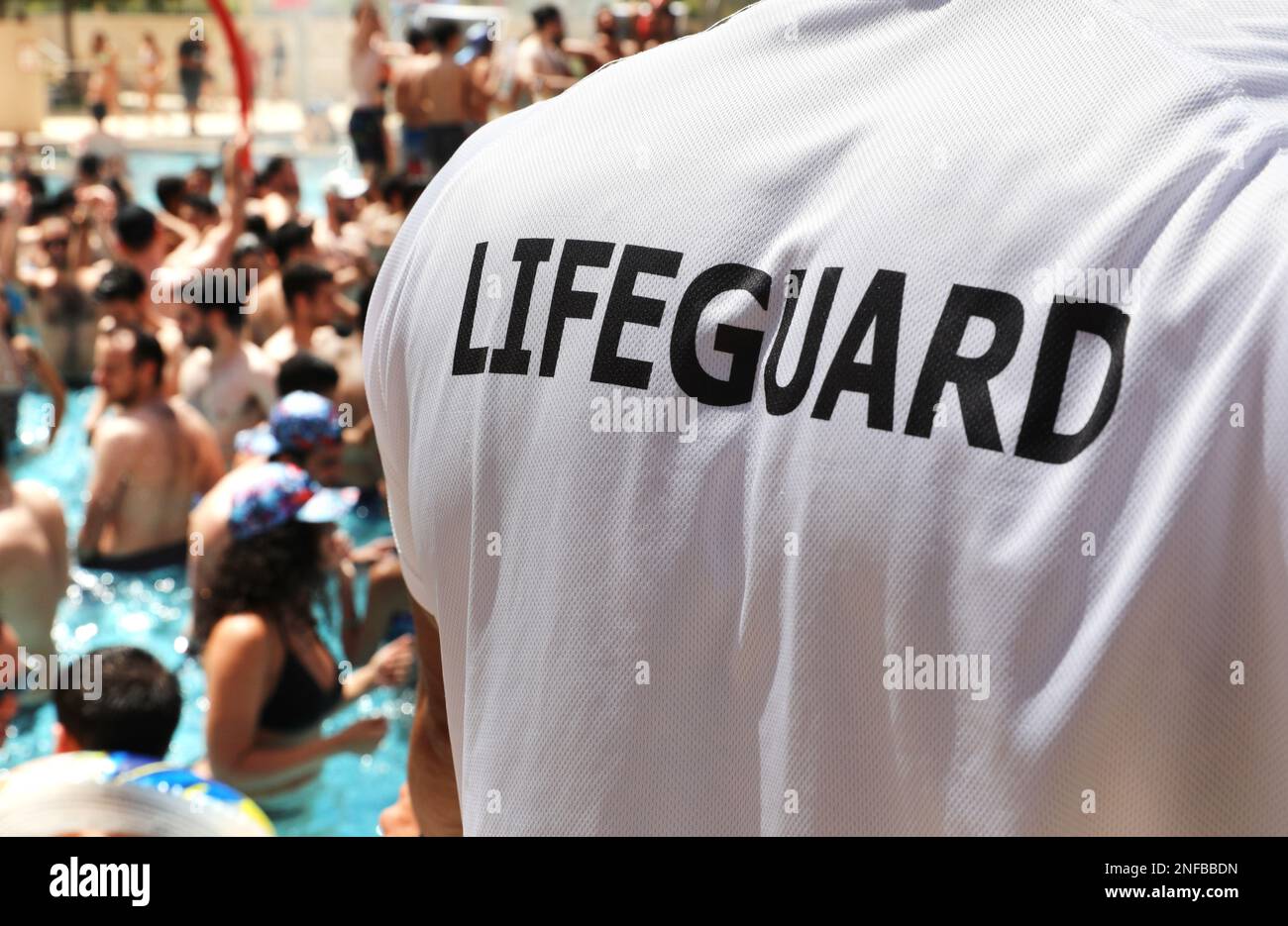Lifeguard on duty at swimming poll. Saving life concept Stock Photo - Alamy