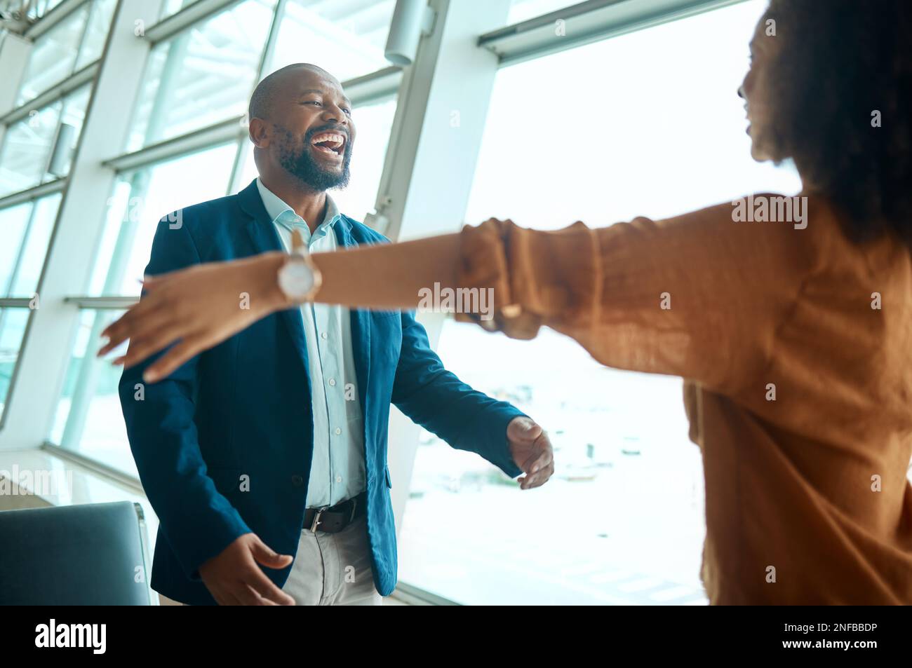 Happy, love and couple hugging in the airport for reunion with care ...