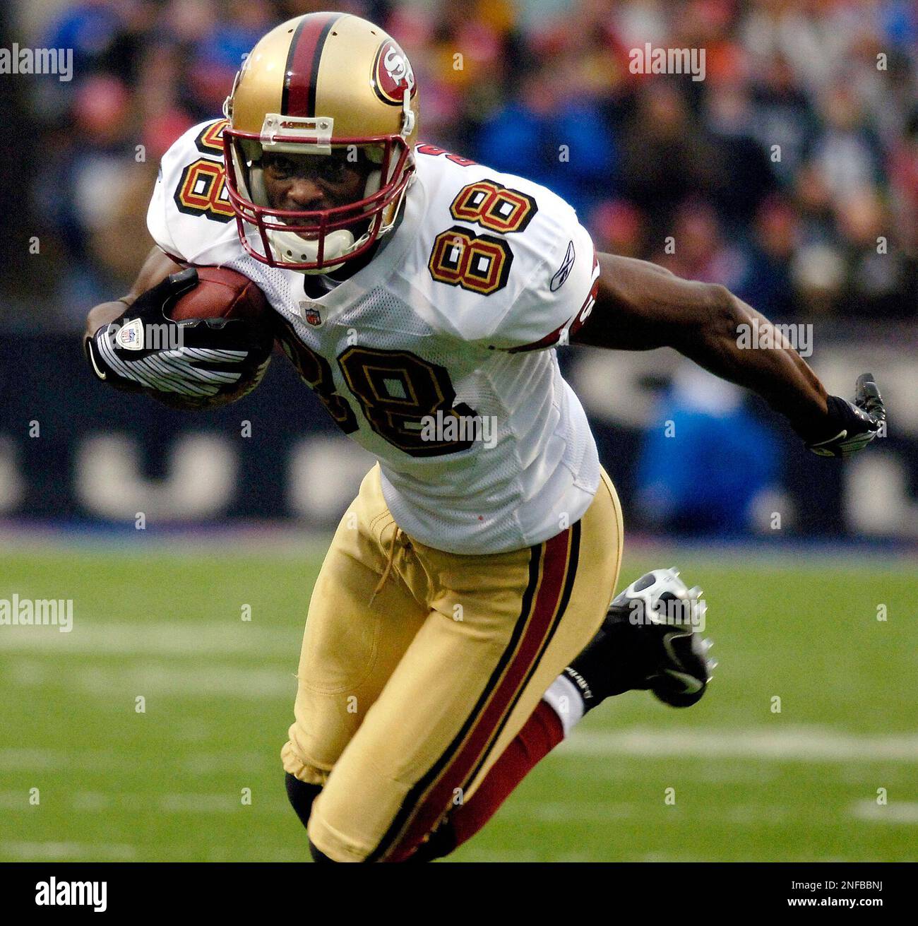 San Francisco wide receiver Isaac Bruce runs the ball after a reception ...