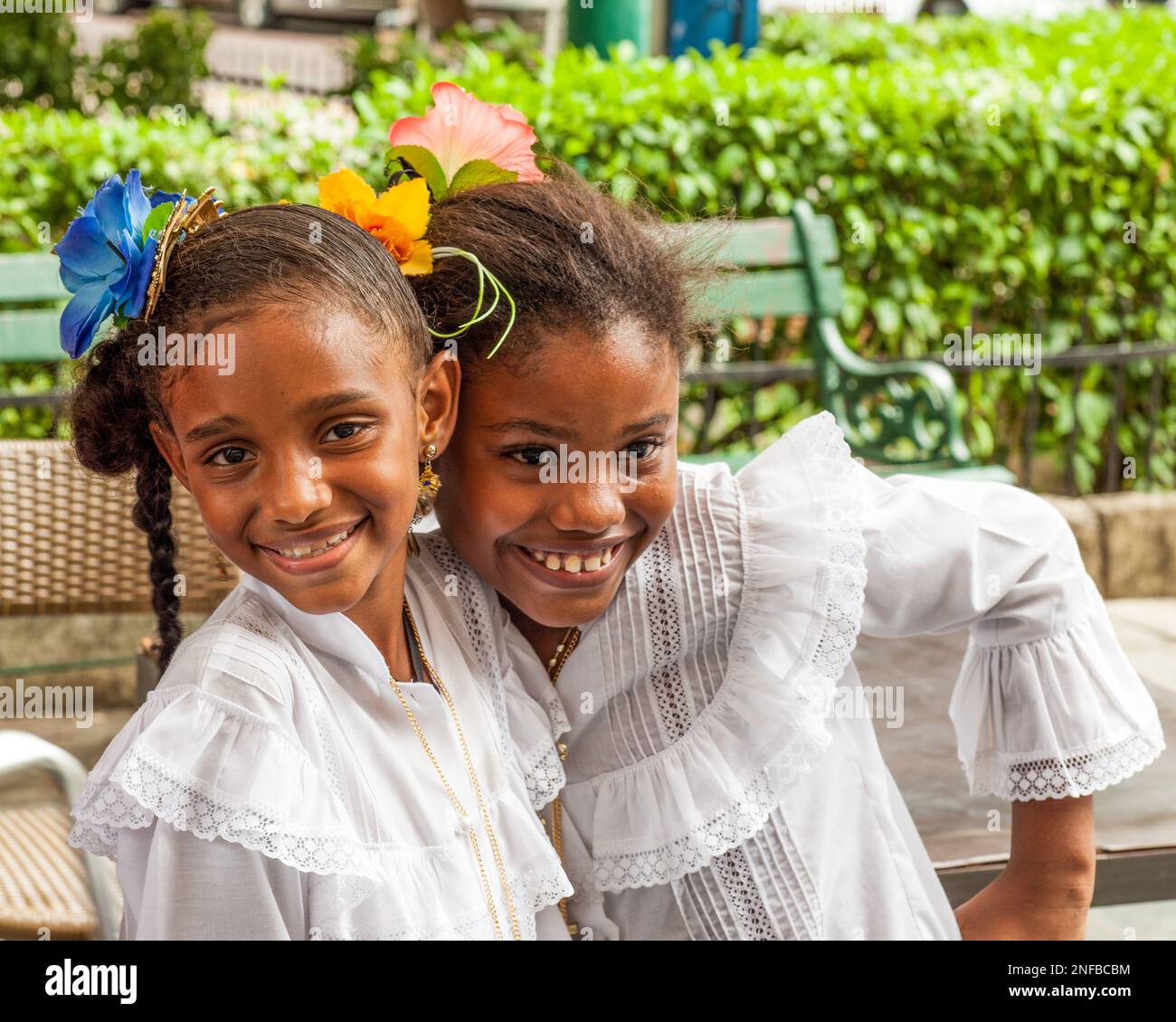 Two young Panamanian schoolgirls of color, hamming it up for the camera ...