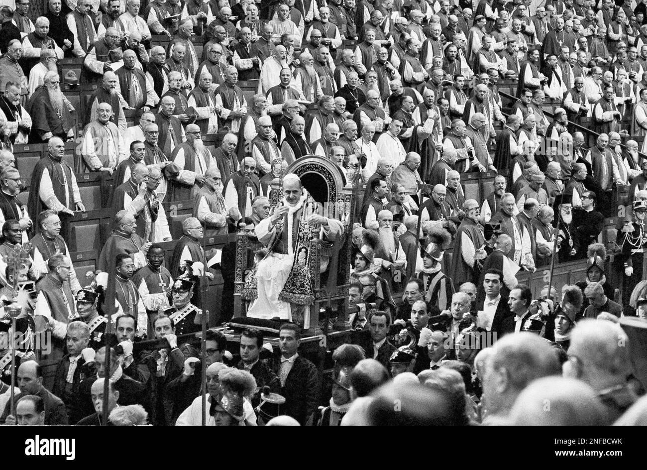 Pope Paul VI gestures to council fathers as he is carried on his ...