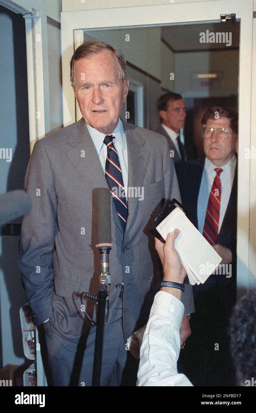 President George Bush talks with reporters aboard Air Force One, Aug ...
